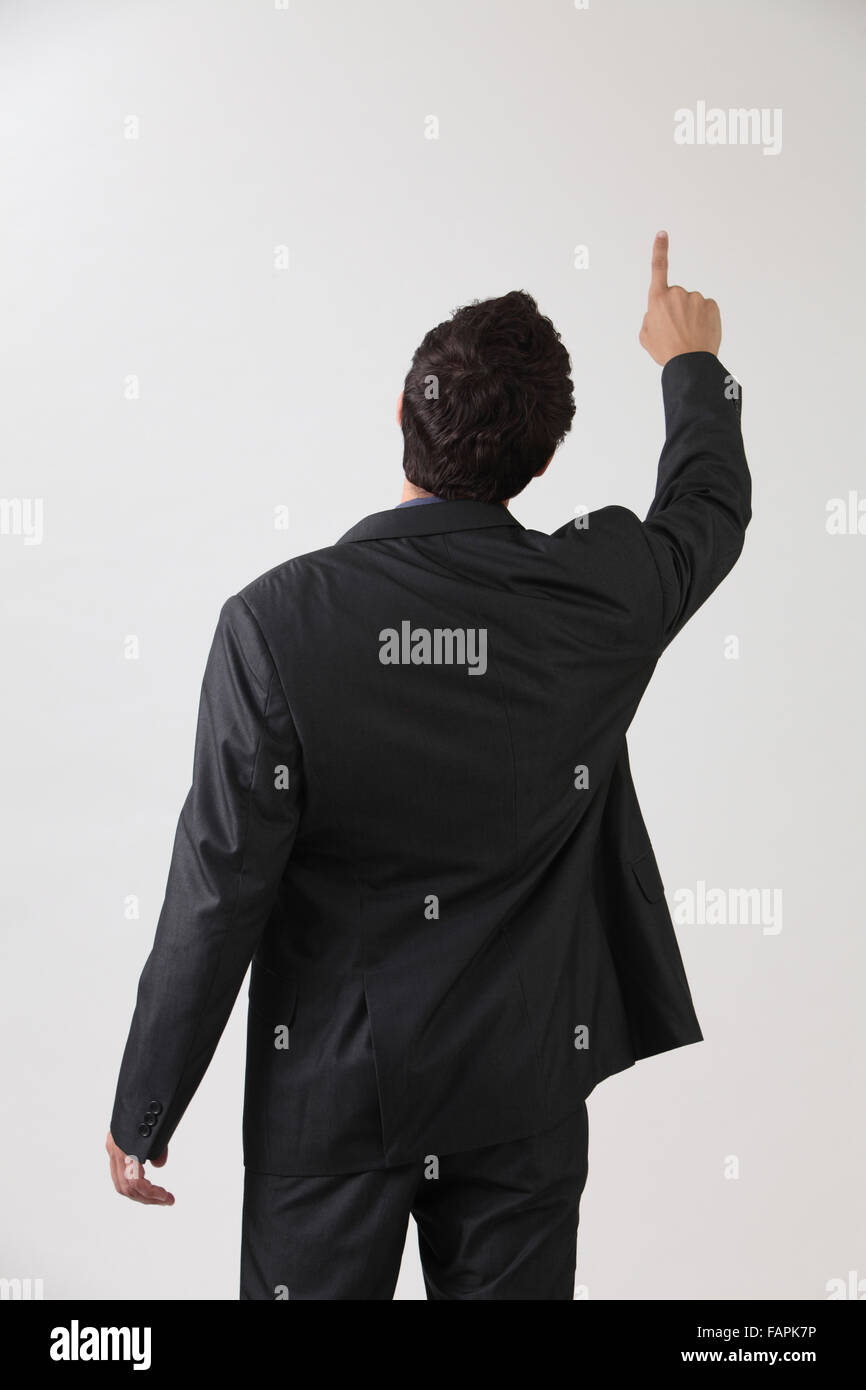 Businessman from behind, pointing at something Stock Photo - Alamy