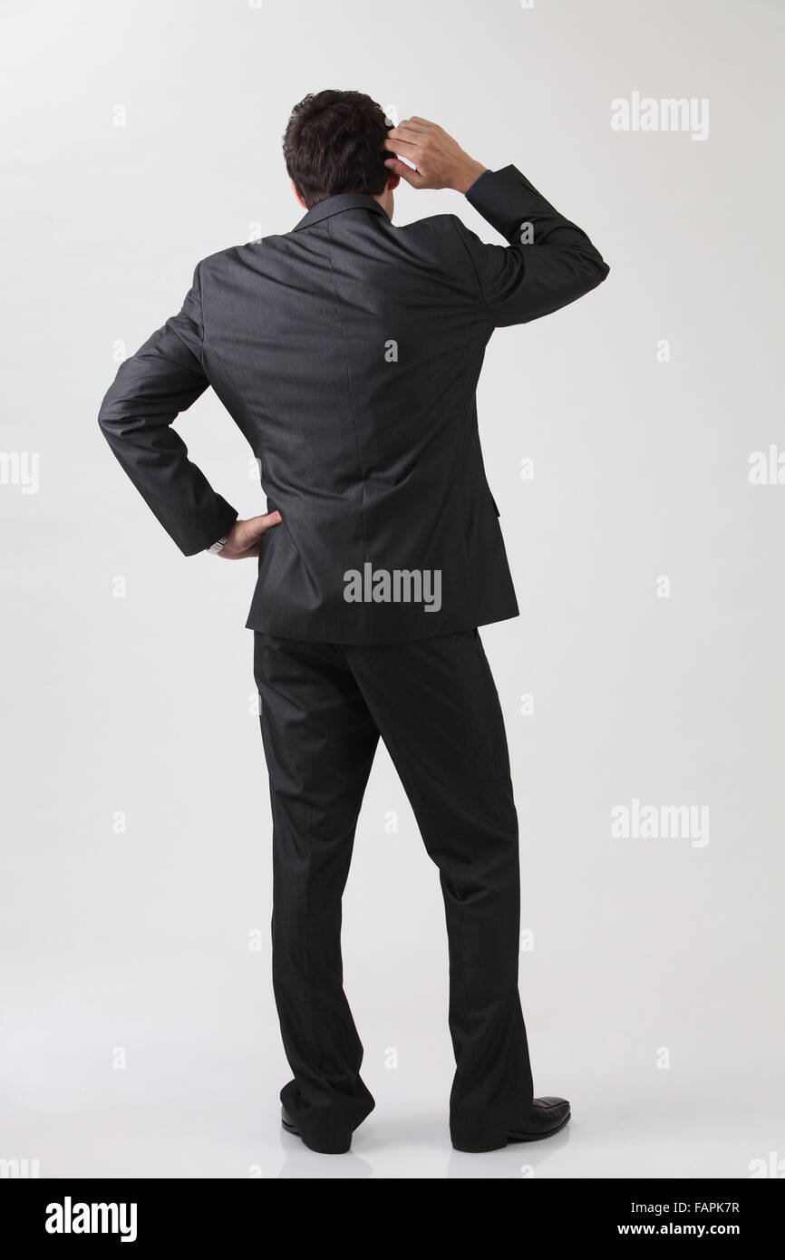 Businessman from behind,with doubt Stock Photo - Alamy