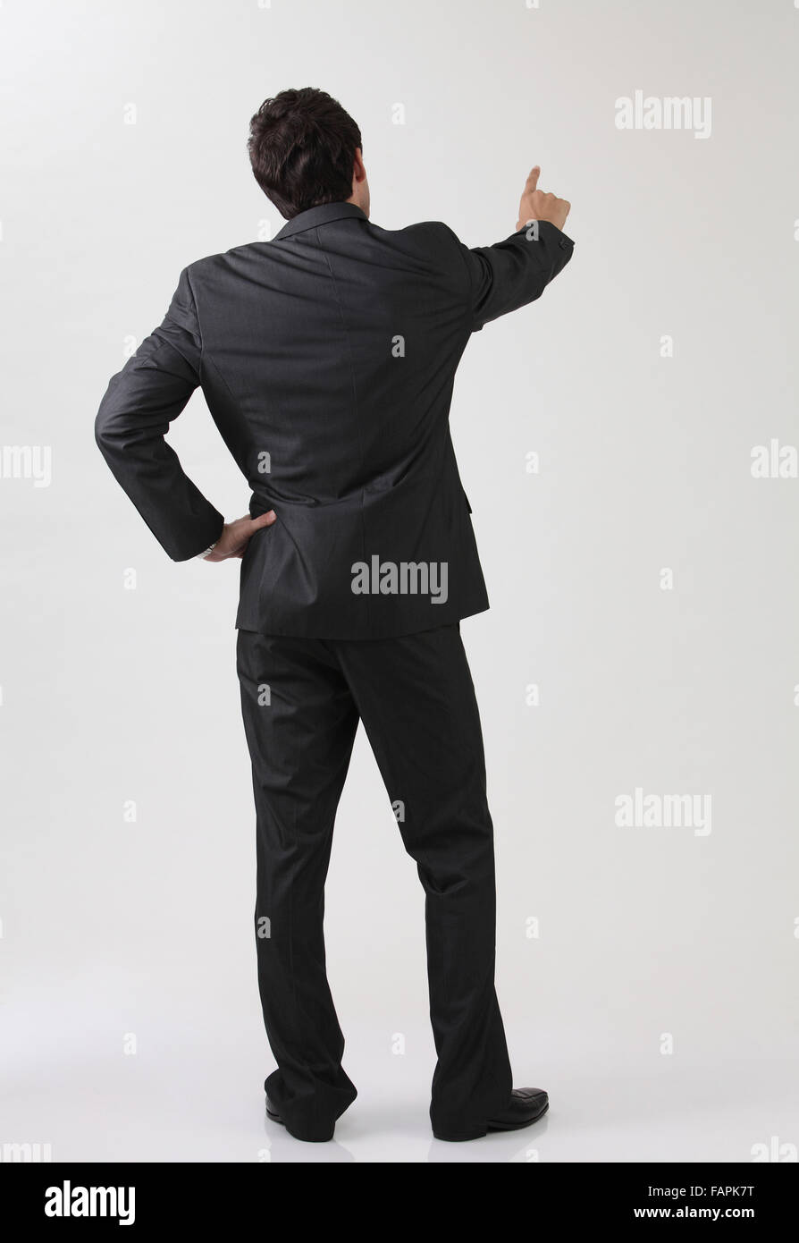 Businessman from behind, pointing at something Stock Photo - Alamy