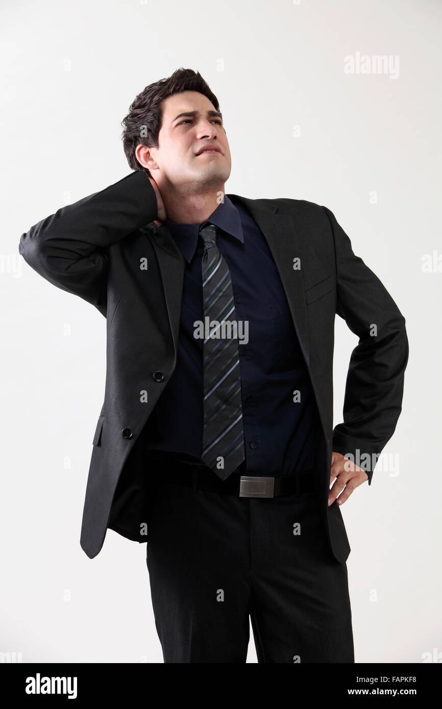 studio shot of Man rubbing his neck Stock Photo - Alamy