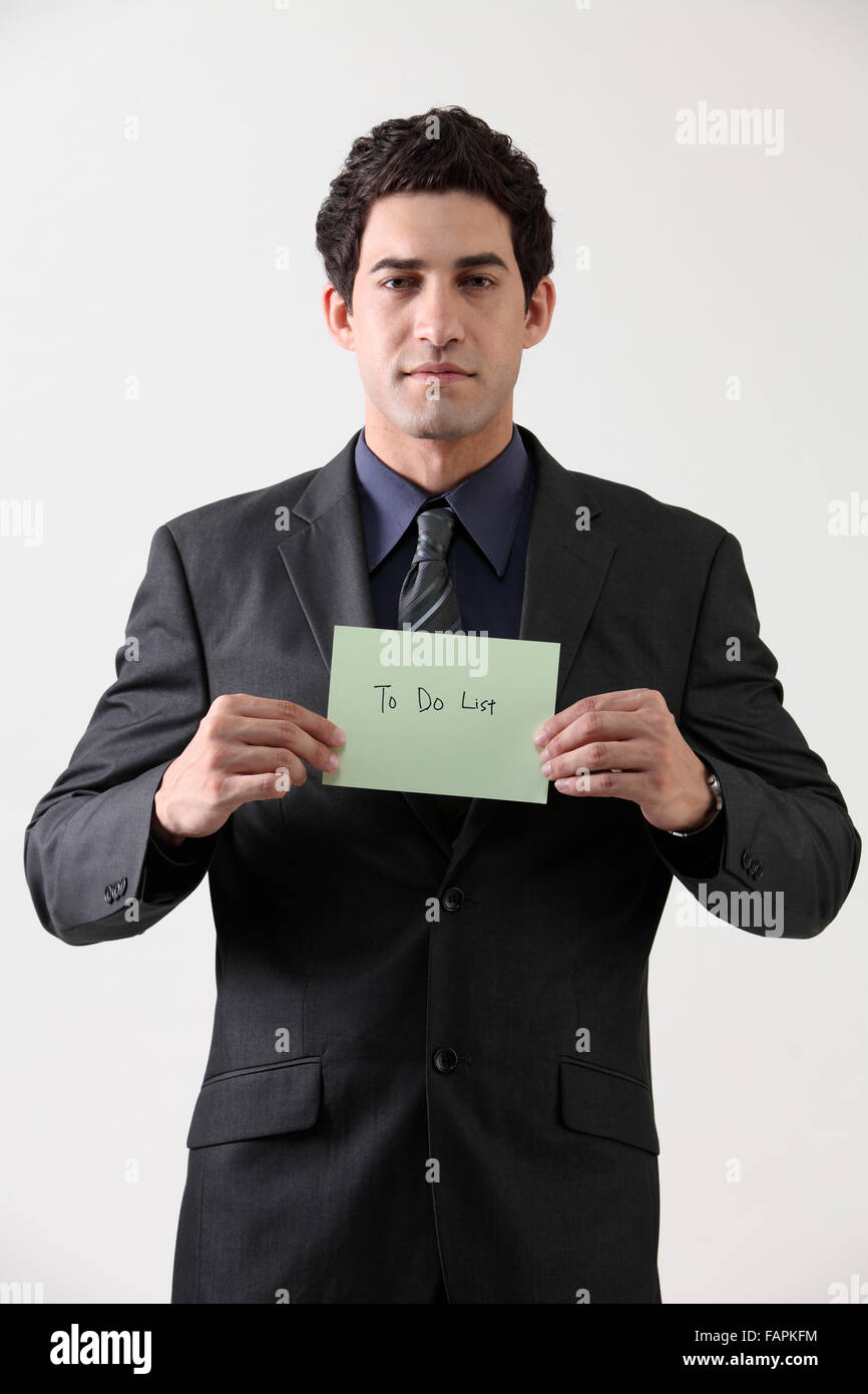 Businessman holding message card, portrait Stock Photo - Alamy Businessman holding message card, portrait Stock Photo - Alamy
