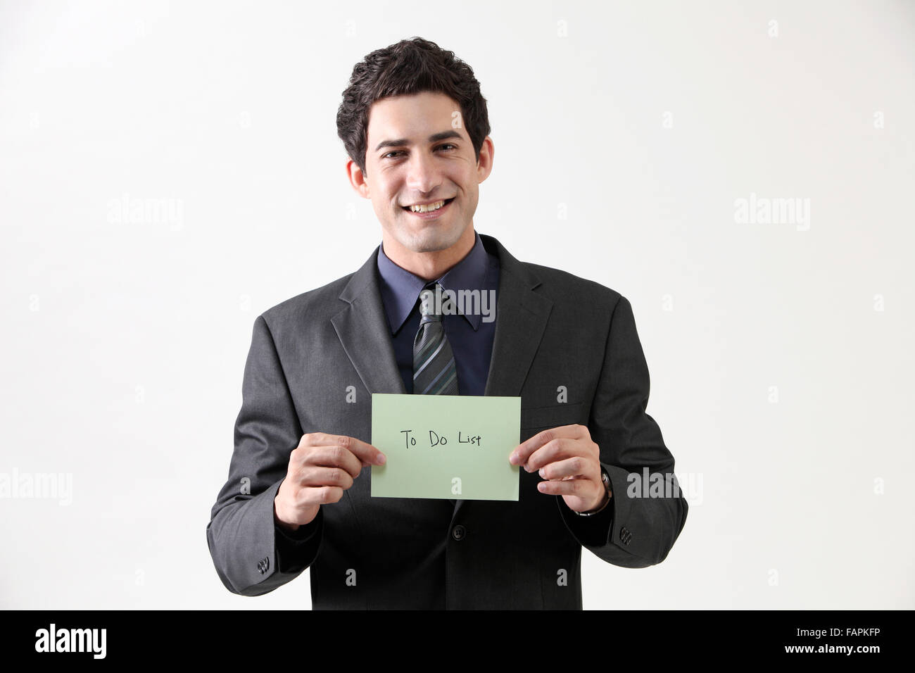 Businessman holding message card, portrait Stock Photo - Alamy