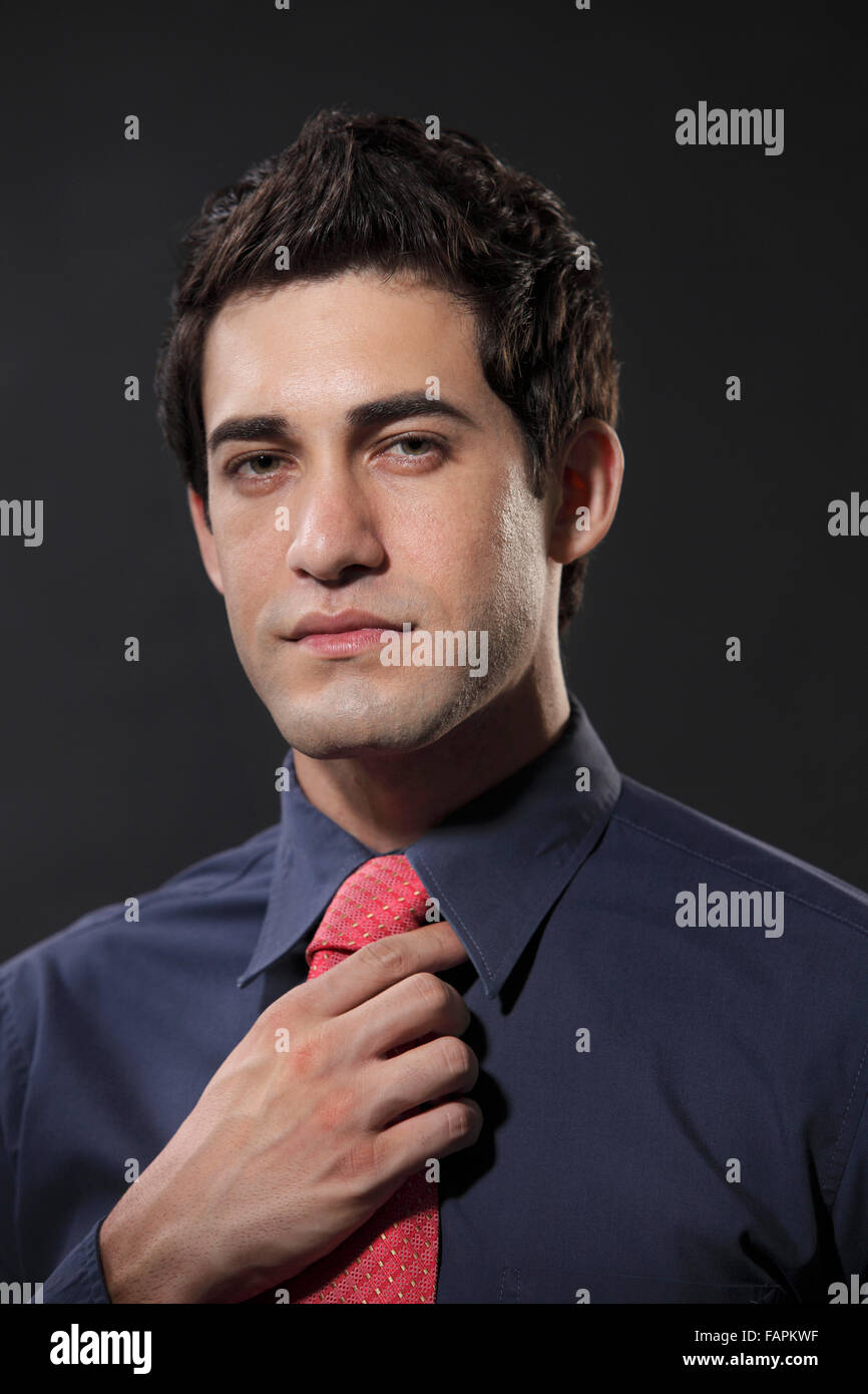 Young Man adjusting his tie Stock Photo - Alamy Young Man adjusting his tie Stock Photo - Alamy