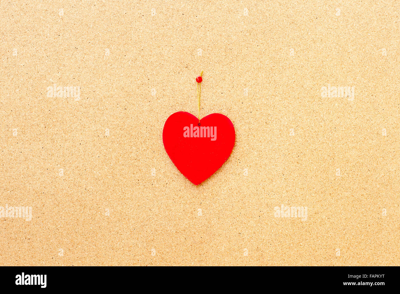 Valentine's day red heart centered pinned on wooden cork board Stock ...
