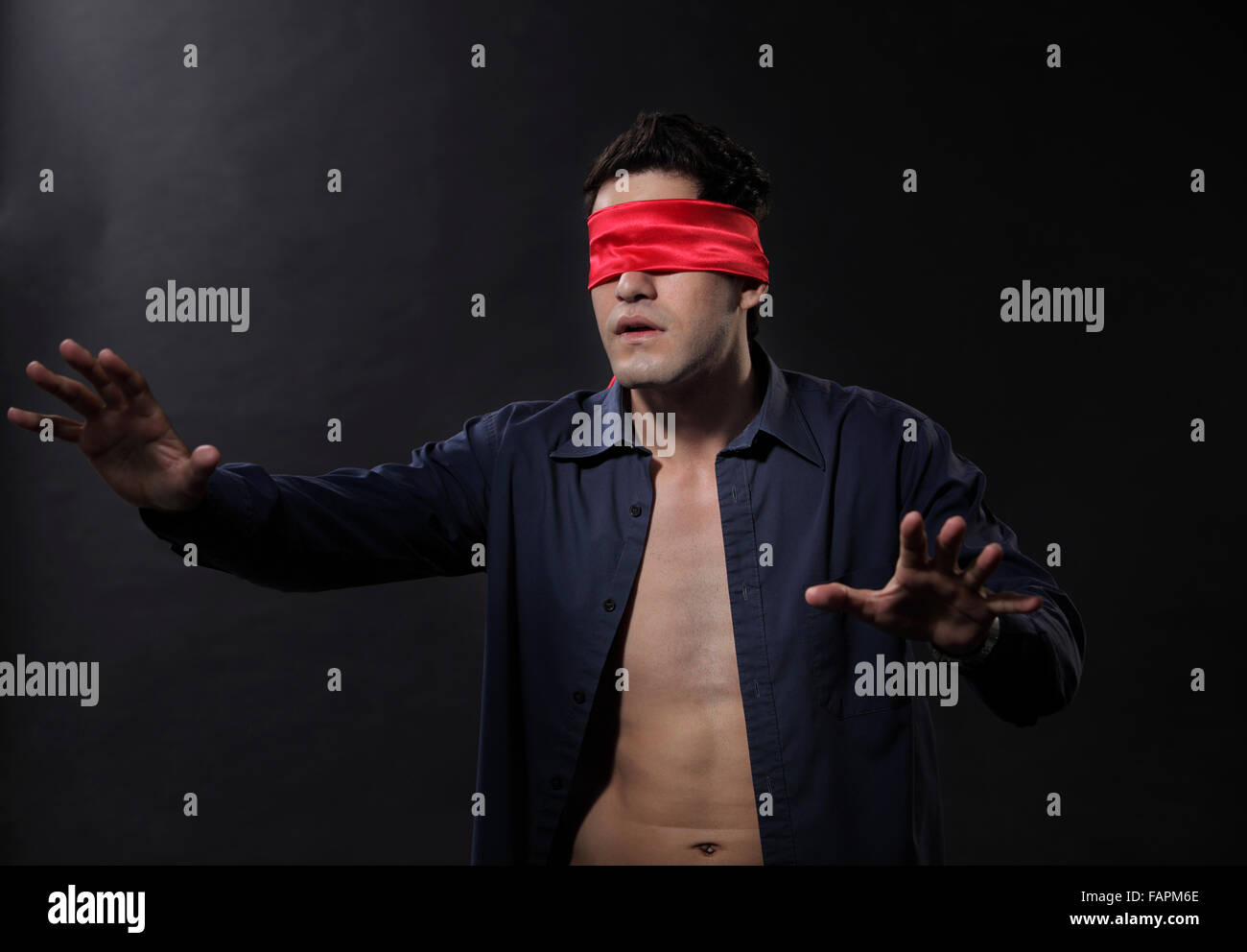 man blindfolded with red cloth Stock Photo - Alamy