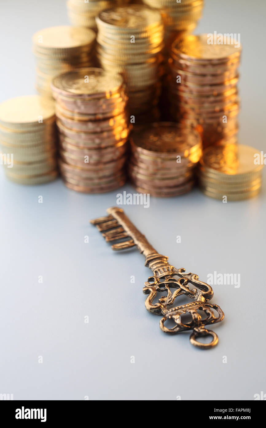 key and stack of coin Stock Photo - Alamy