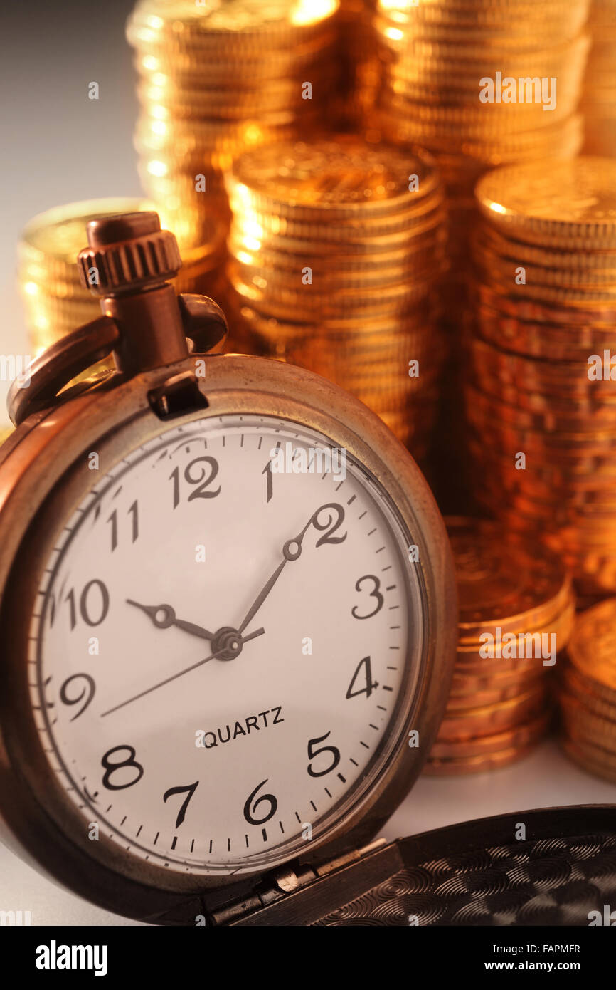 watch and pile of the coin Stock Photo - Alamy