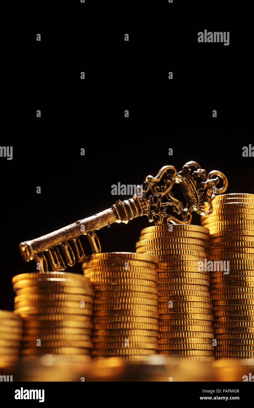 key resting on the stack of coin Stock Photo - Alamy