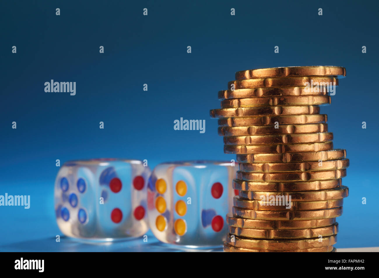 dice and stack of coins Stock Photo - Alamy