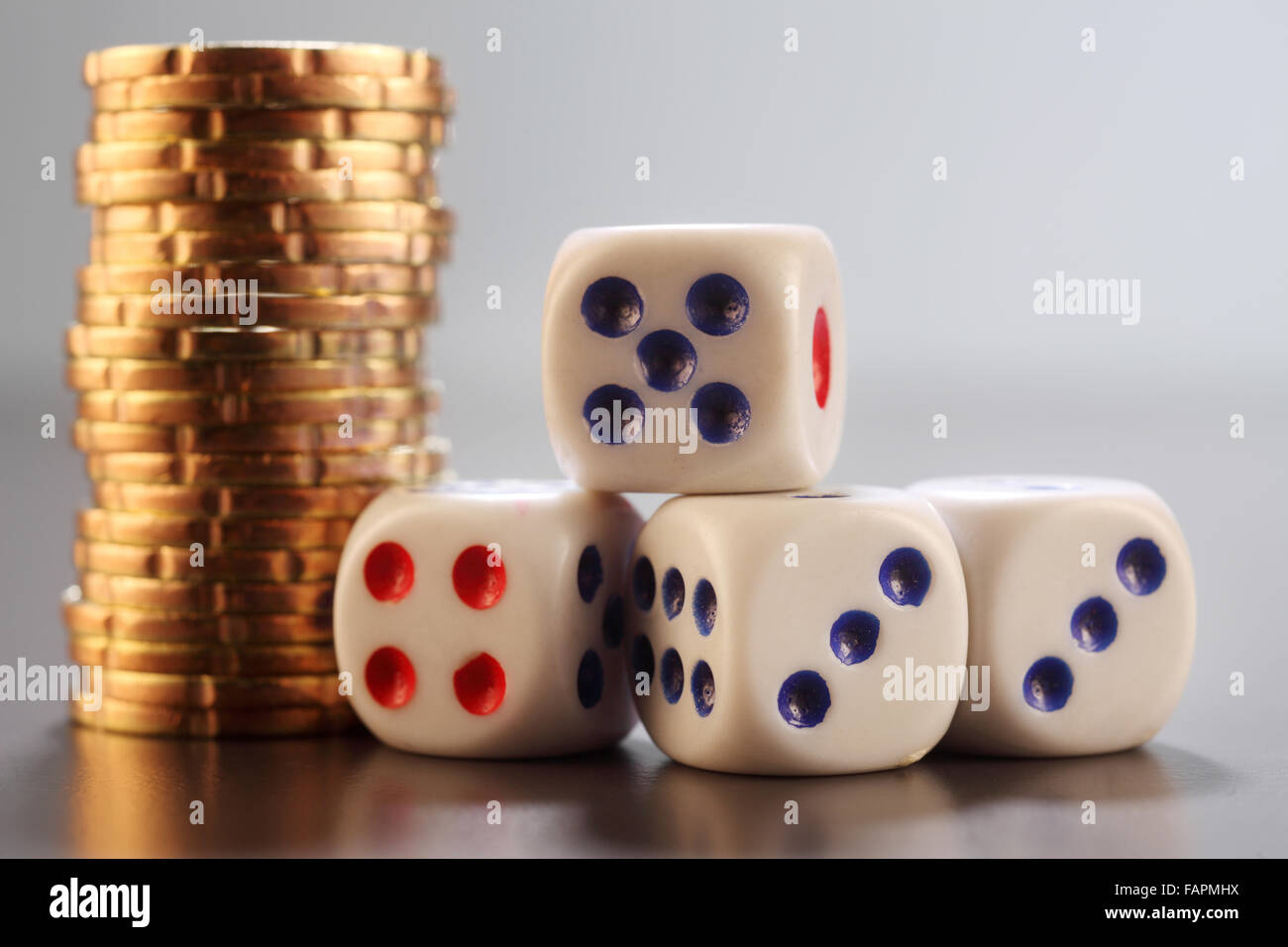 stack of the coin and dices Stock Photo - Alamy