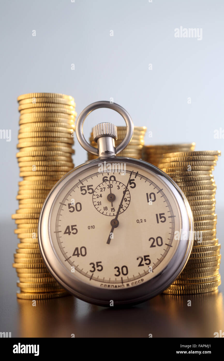 stop watch with stack of coin Stock Photo - Alamy