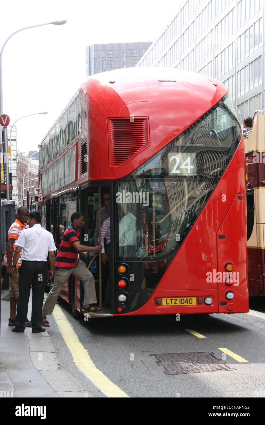REAR VIEW OF RED LONDON NEW ROUTEMASTER BUS AT A BUS STOP SHOWING ...