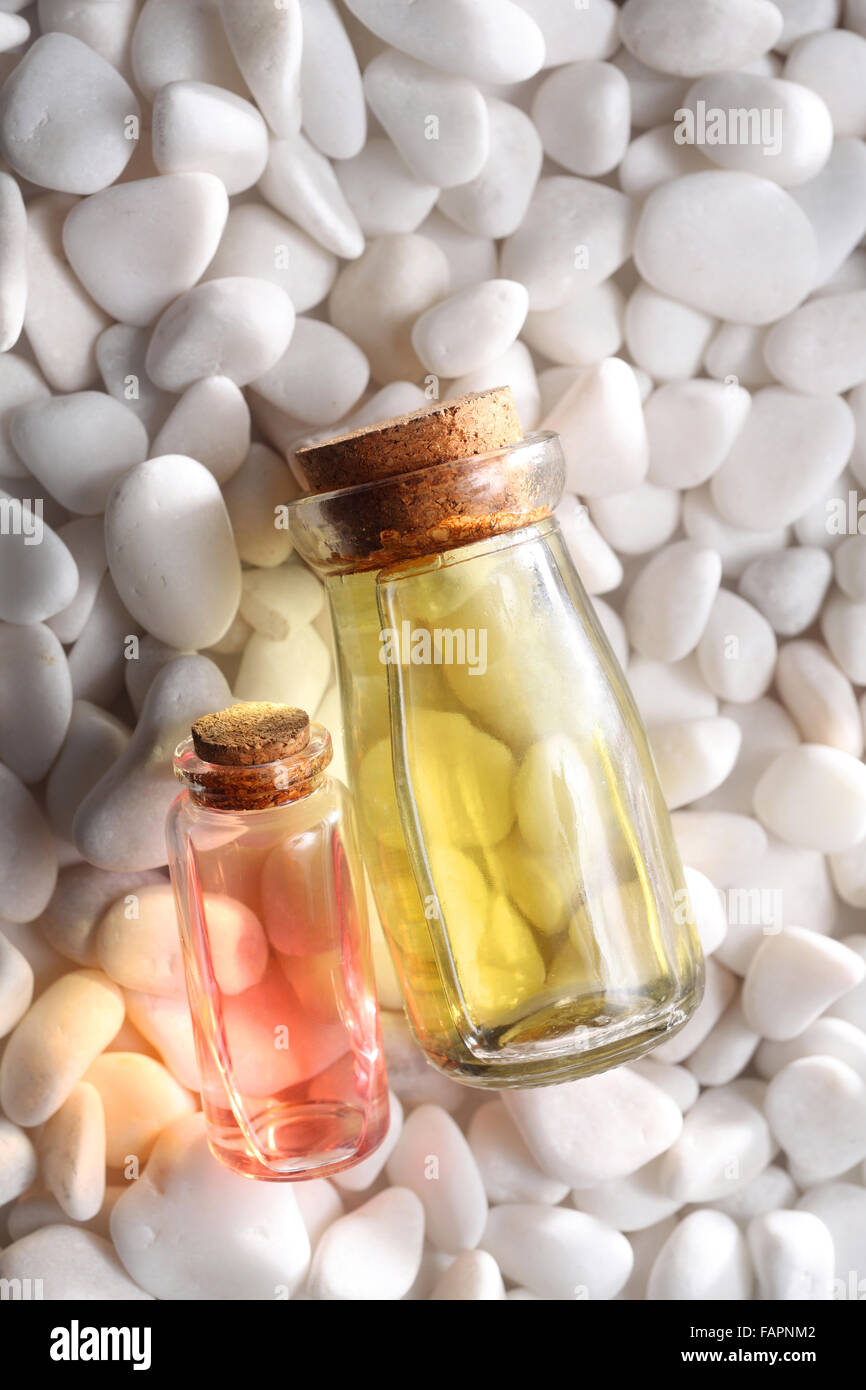 bottles of the massage oil on white stone Stock Photo - Alamy