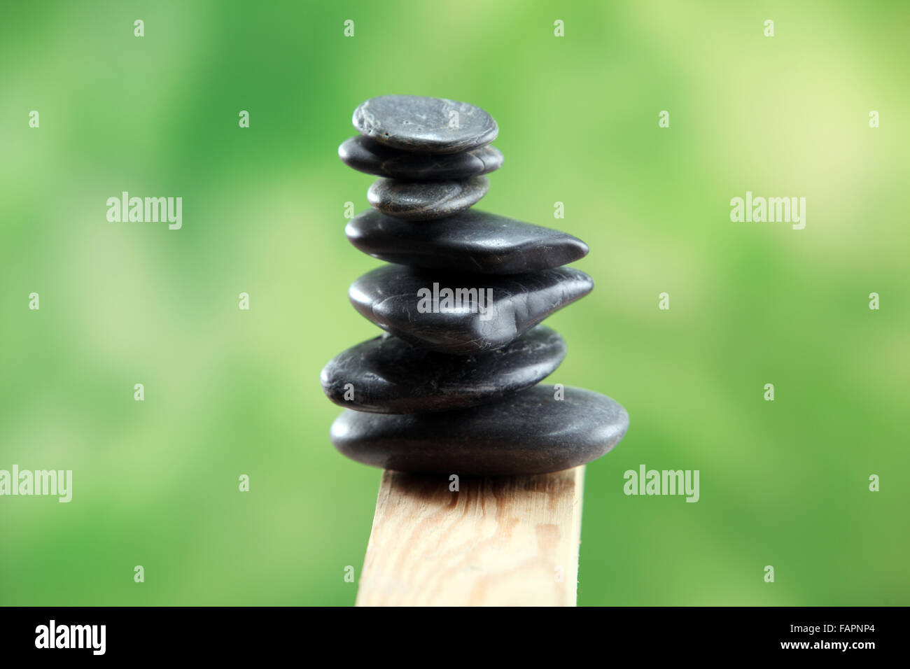 stack of stone on the green color background Stock Photo - Alamy