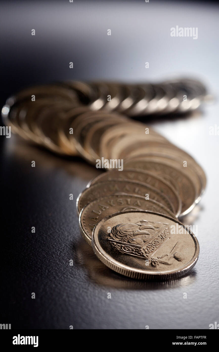 Row of coins on the black background Stock Photo - Alamy