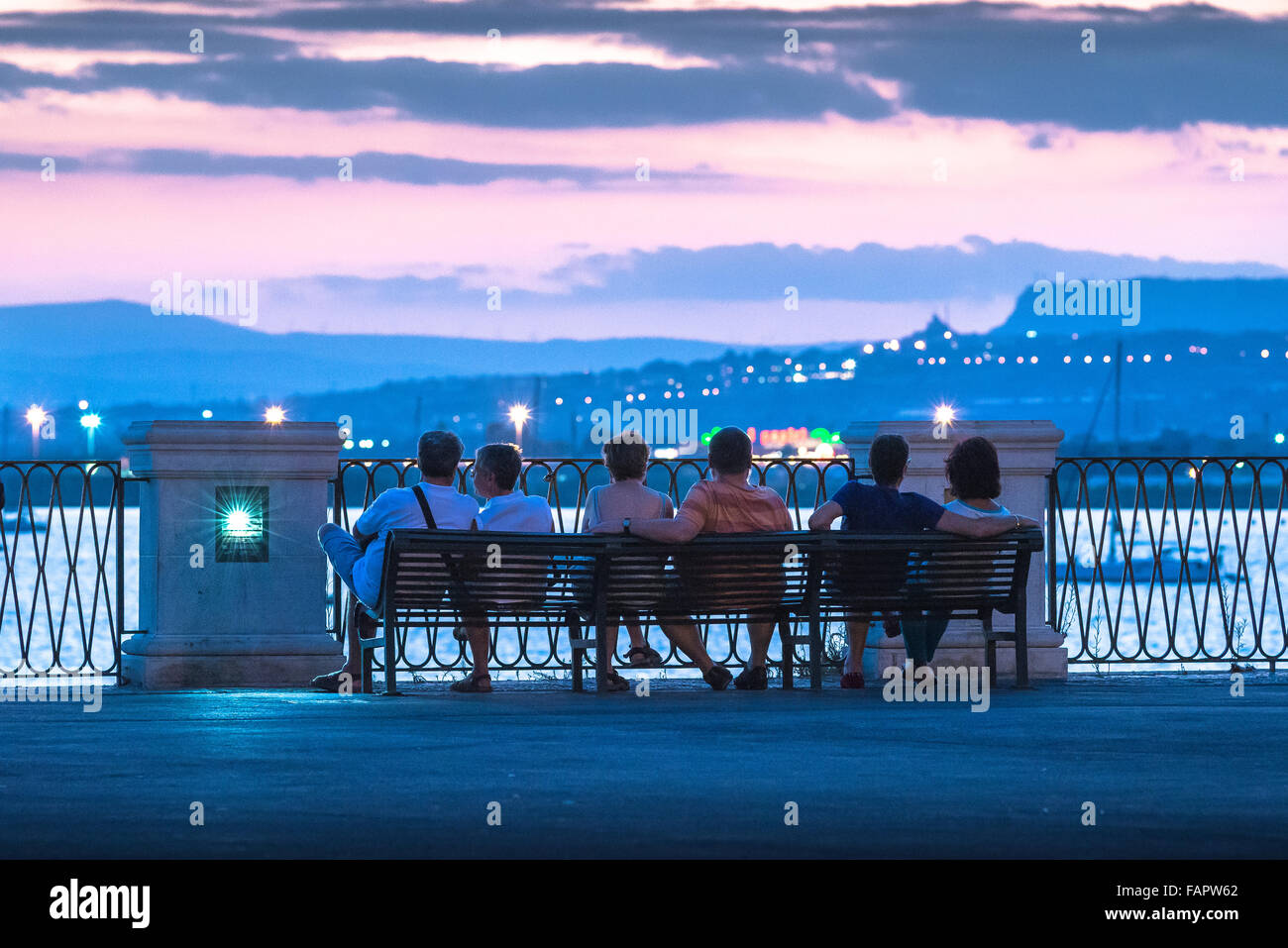 Friends sitting together, rear view of a group of middle aged friends ...