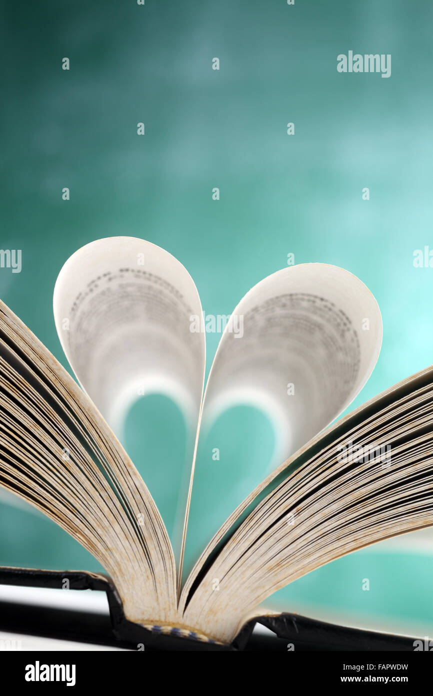 book with open page folded a heart shape Stock Photo - Alamy