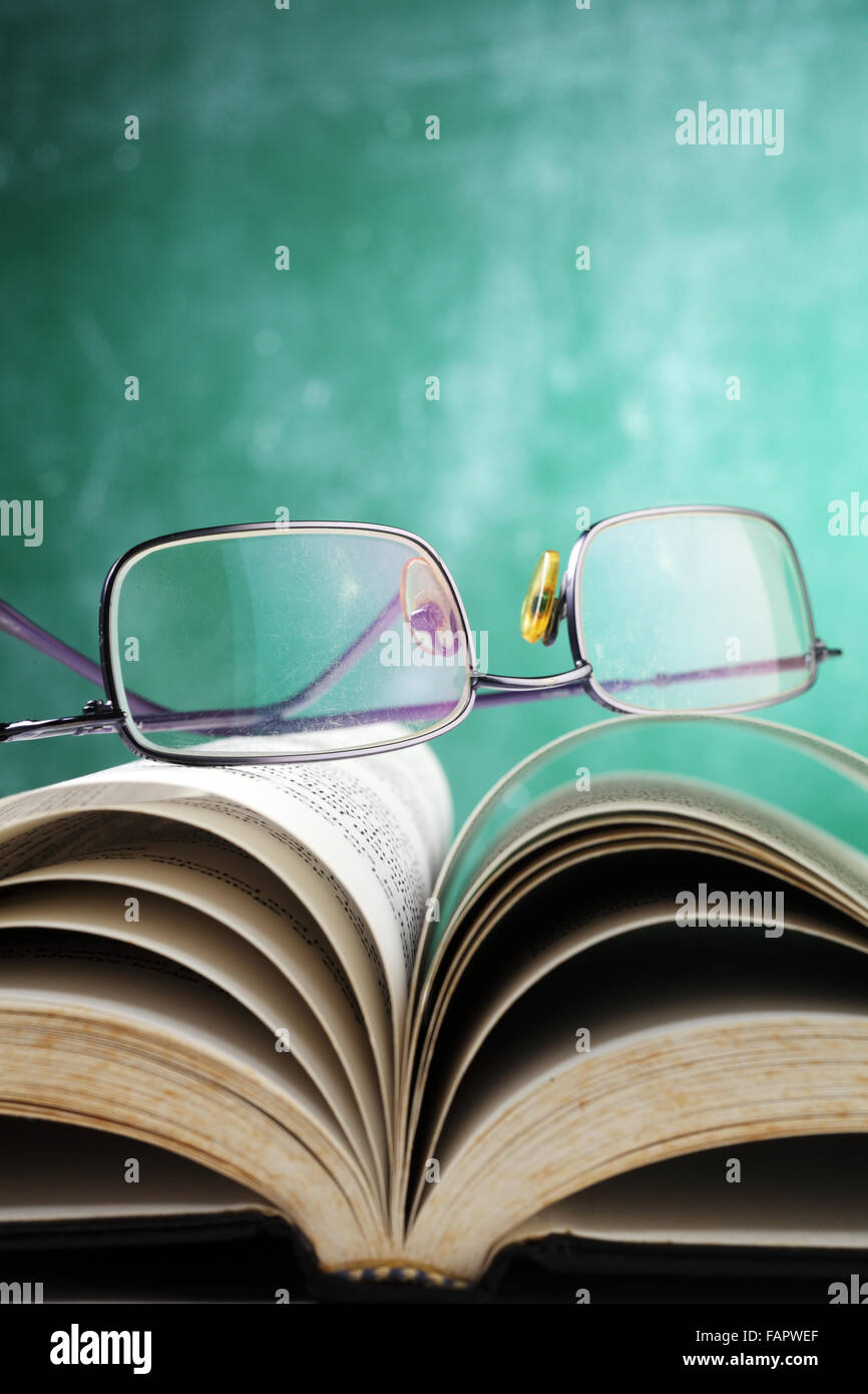 slelective focus on the spectacles on the book Stock Photo - Alamy
