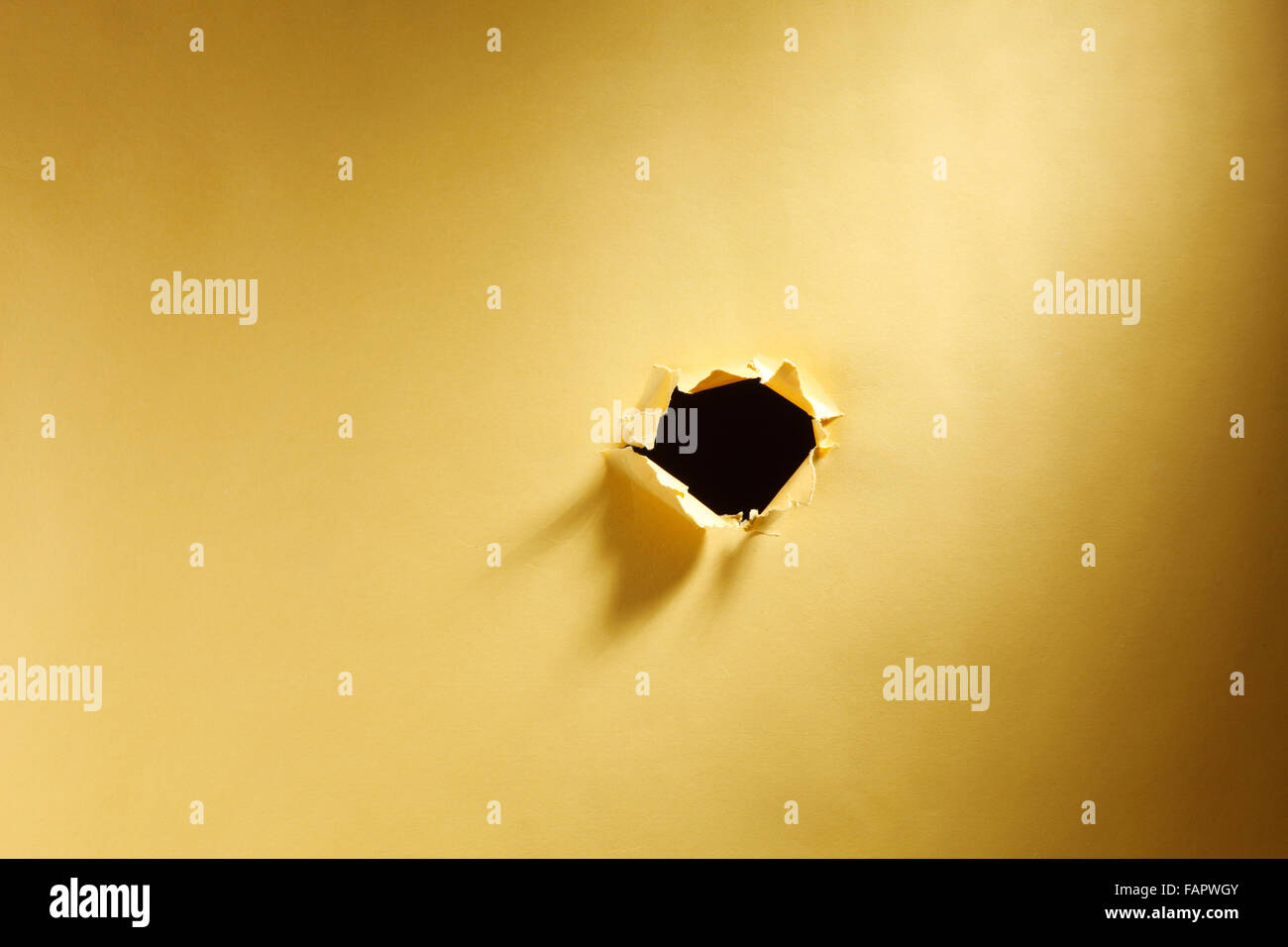 stock image of the torn on the yellow color paper Stock Photo - Alamy