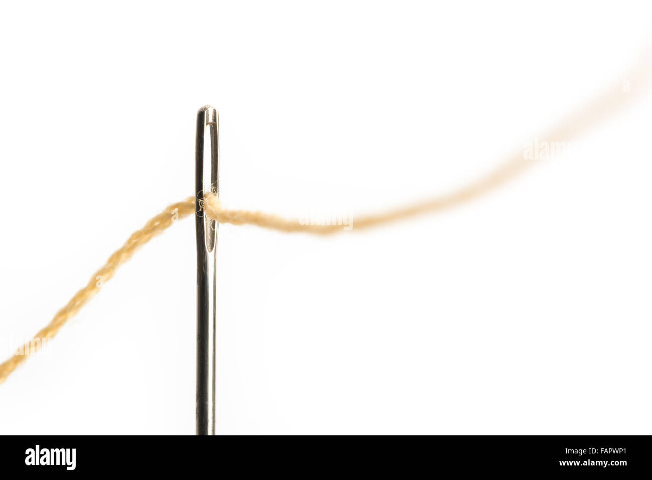 cotton and thread inserted through needle eye steel sewing reel of thin ...