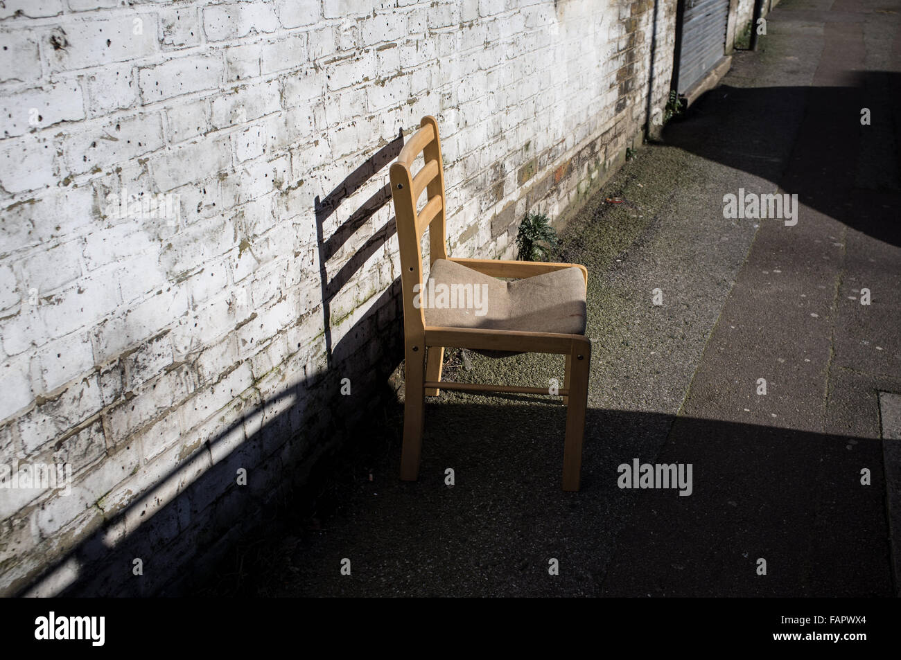 Chair left on street in Leyton, East London Stock Photo - Alamy