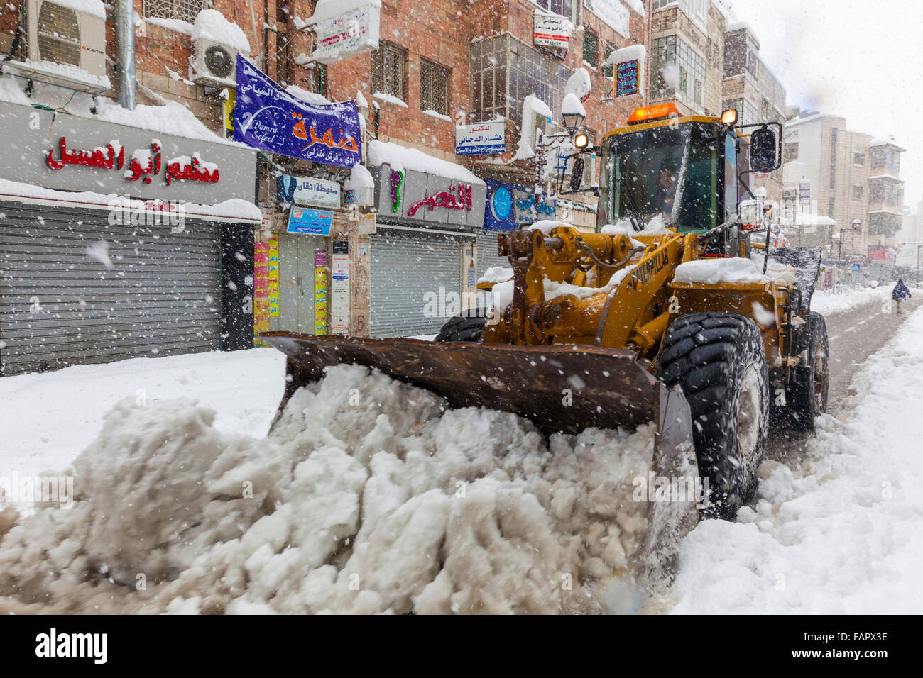 A tractor clearing eh snow from the road in Palestine Stock Photo - Alamy