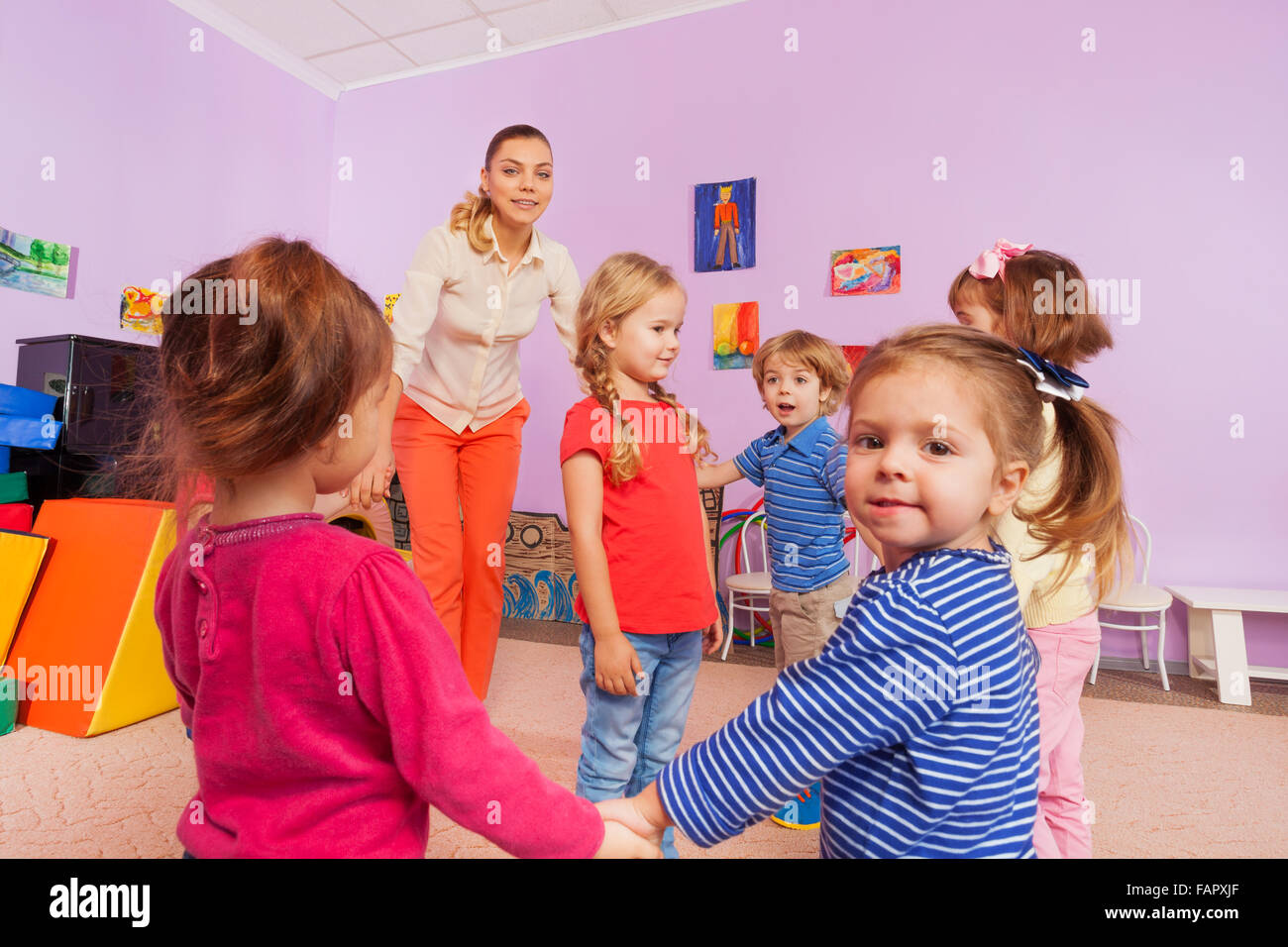 Group of children roundelay around little girl Stock Photo - Alamy
