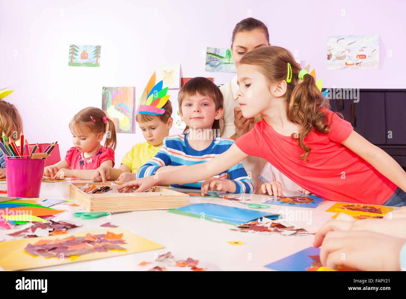 Girl takes paper to make and image in class Stock Photo - Alamy