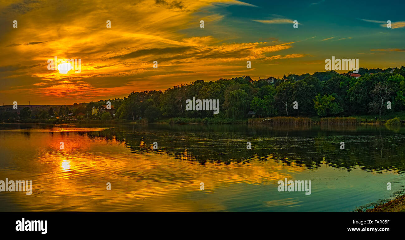 Sunset over the lake Stock Photo - Alamy