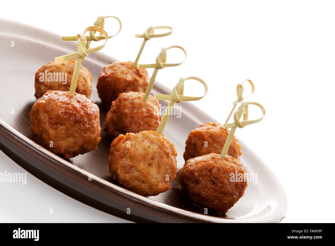 Meatballs canape on ceramic tray isolated on white background. Culinary ...