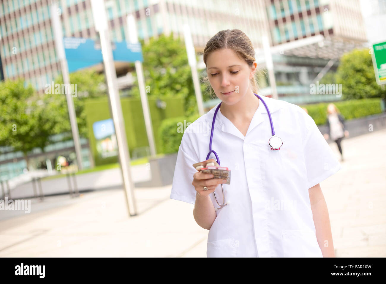 young doctor checking the medication of a patient Stock Photo - Alamy