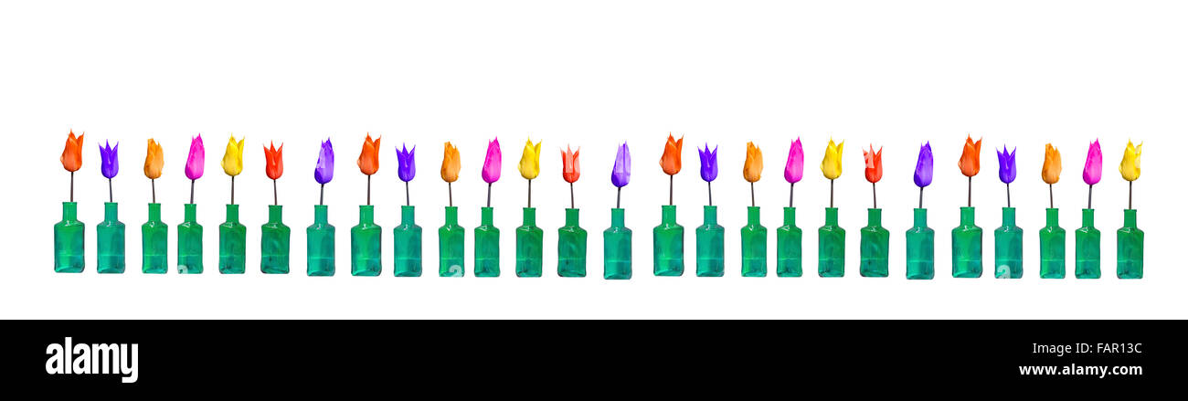 Green glass bottles and colorful tulips spring margin isolated on white ...