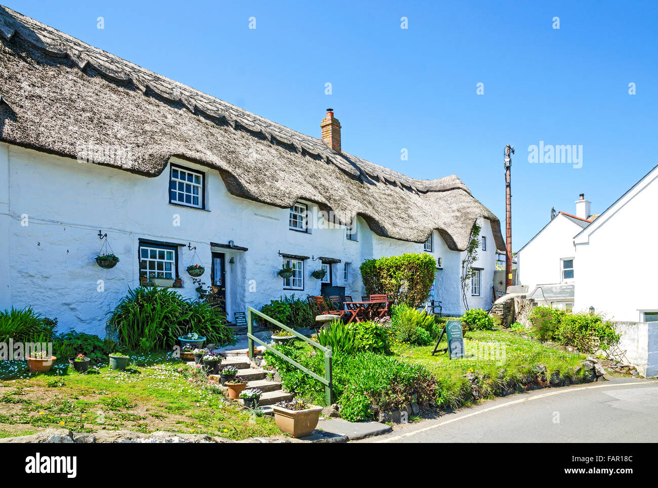 A traditional thatched roof cottage at Coverack in Cornwall, England ...