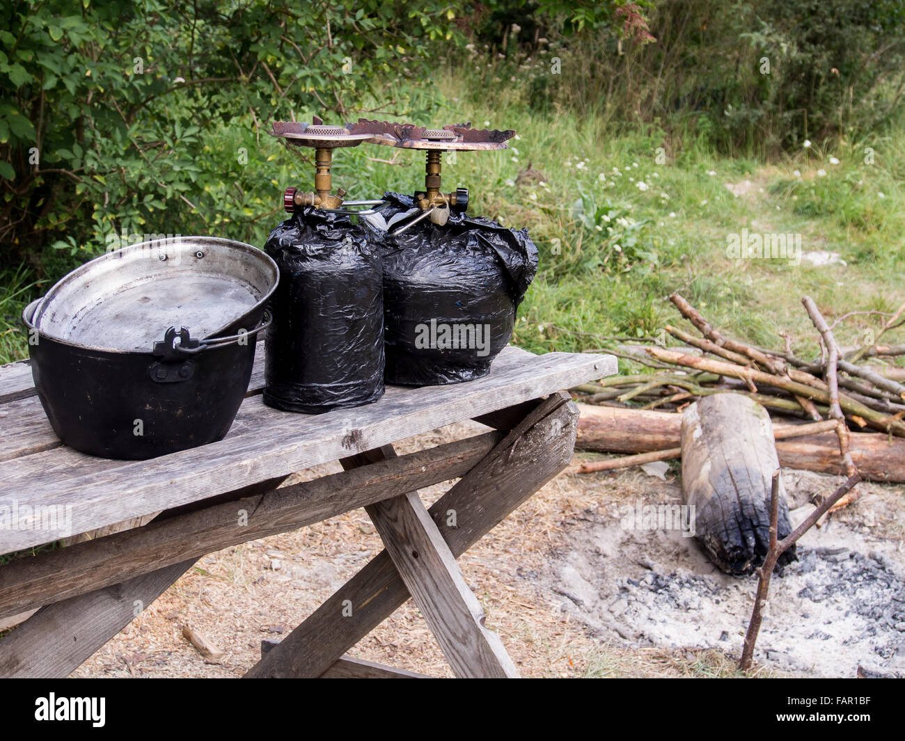 Two gas cylinders for tourist standing on a wooden table next to a ...