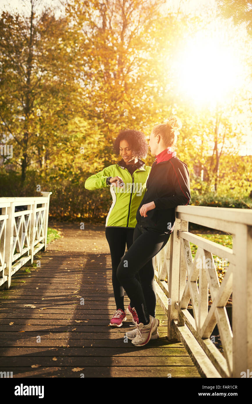 Young women standing on bridge before starting exercise Stock Photo - Alamy