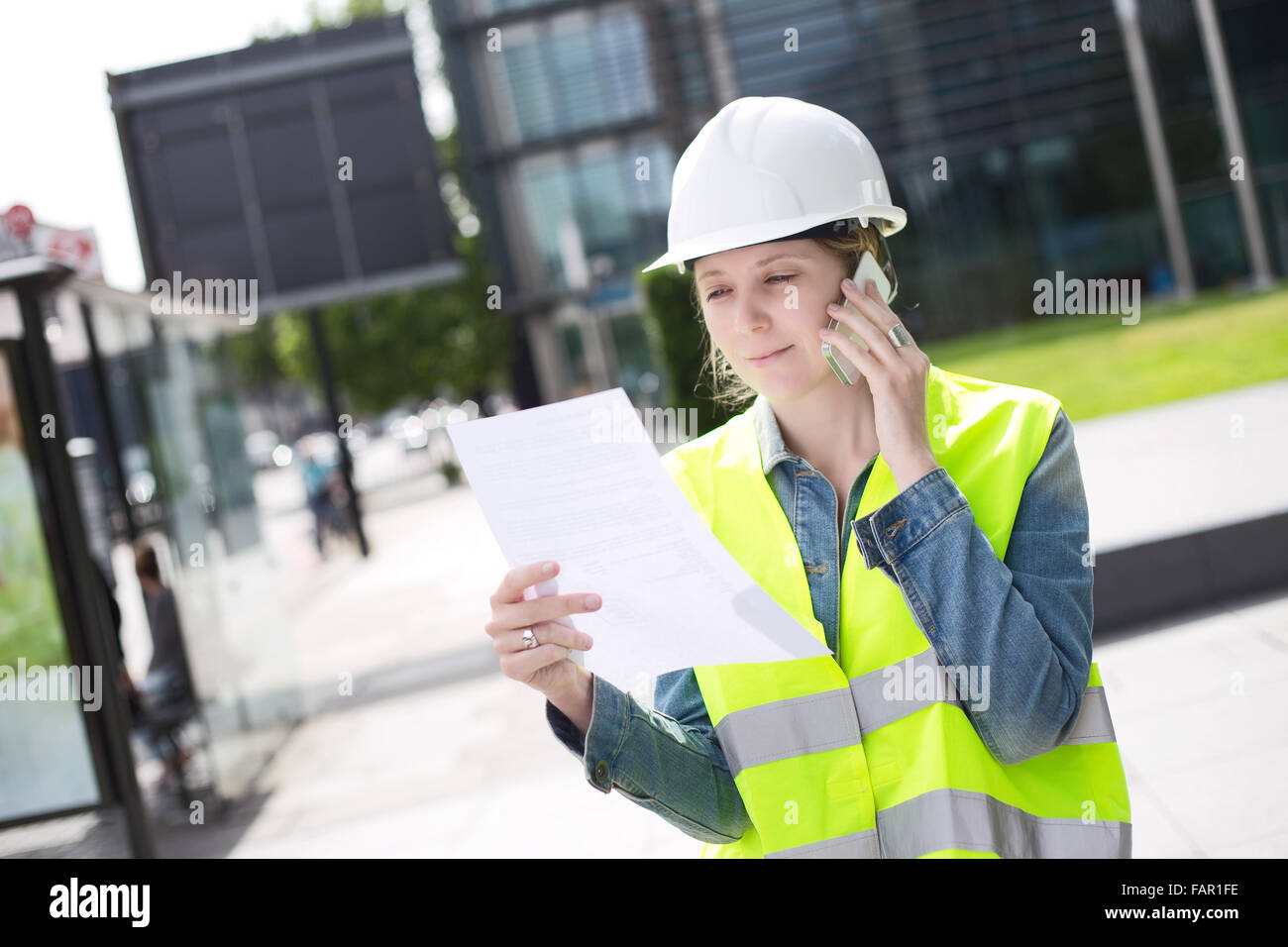 construction worker reading a letter and talking on the phone Stock ...