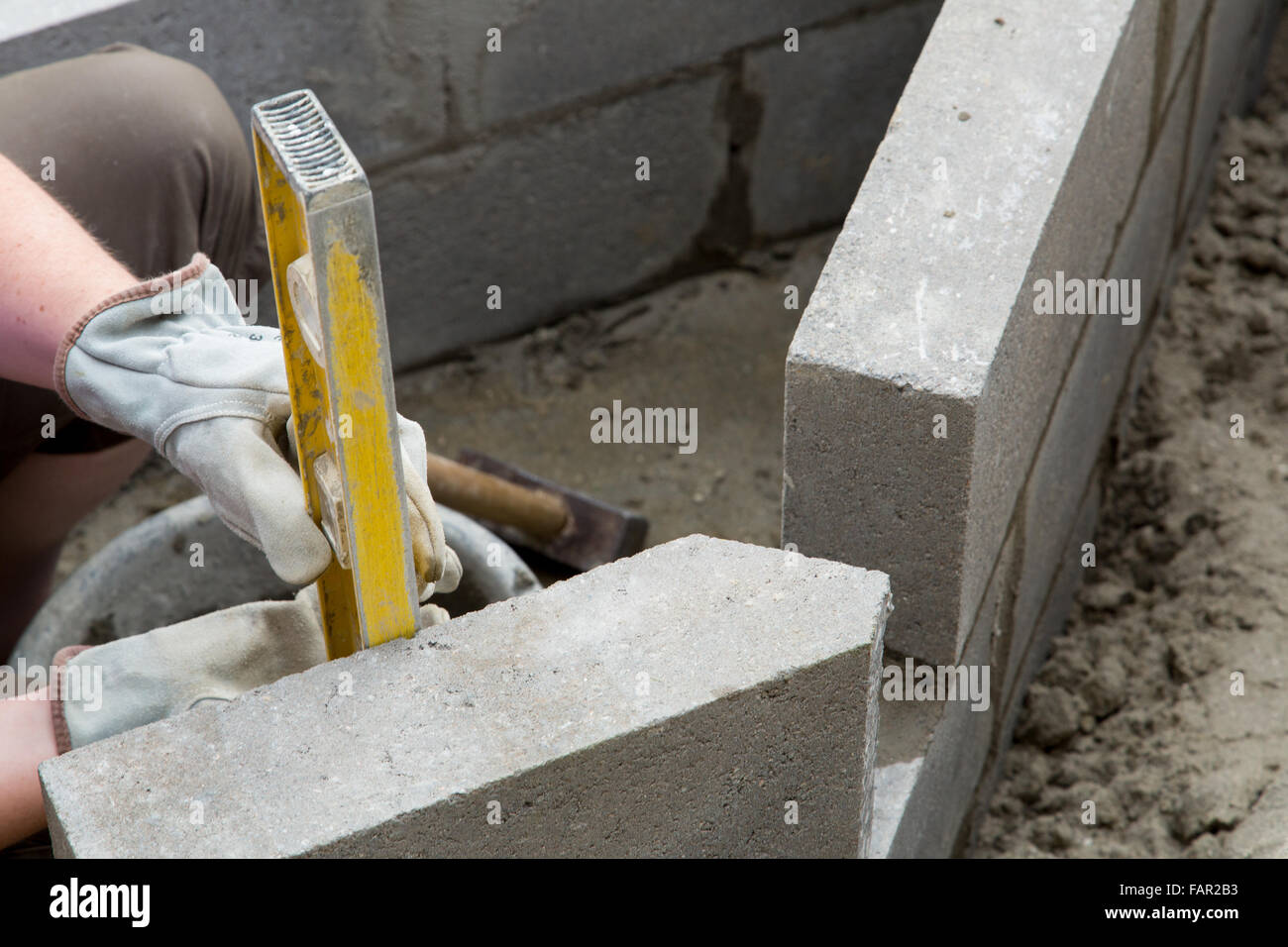 Yellow spirit level on a constructed wall outdoors Stock Photo - Alamy