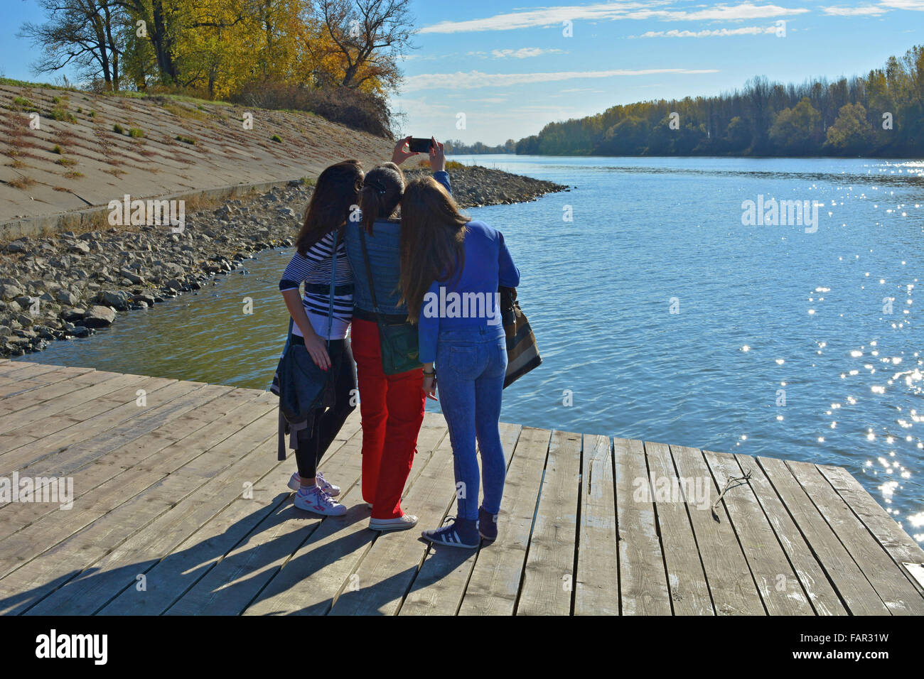 Girls on river pontoon right your self Stock Photo - Alamy