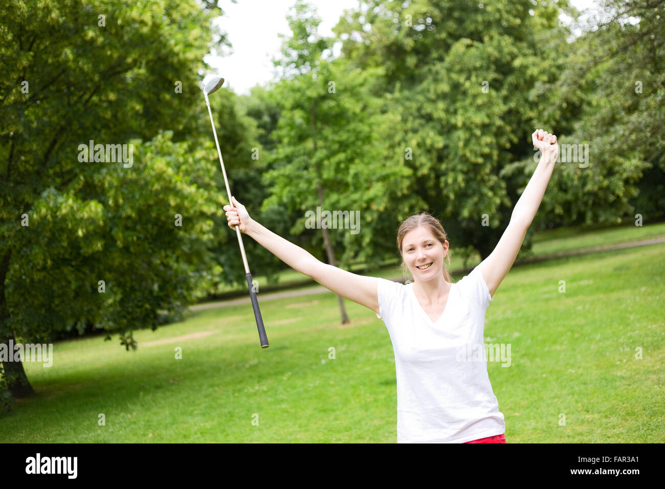 young woman celebrating a hole in one on the golf course Stock Photo ...