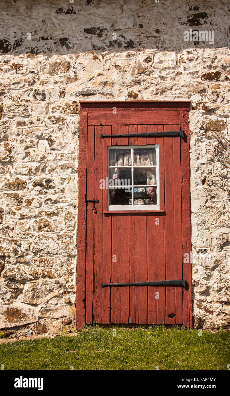 Vintage farmhouse red colour wood front door and red white stone ...