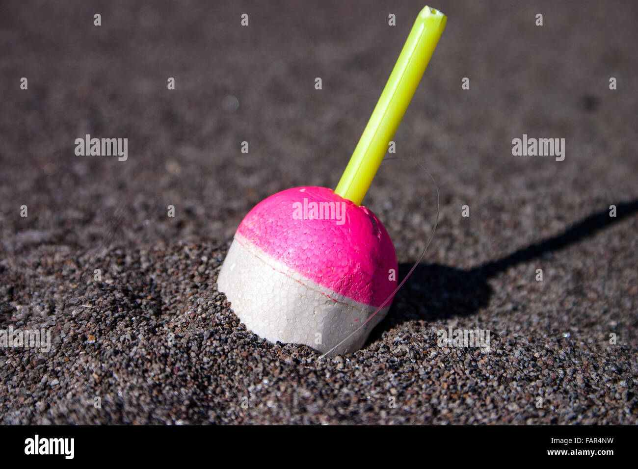 Fishing float stuck in sand of a dried out creek bed Stock Photo - Alamy