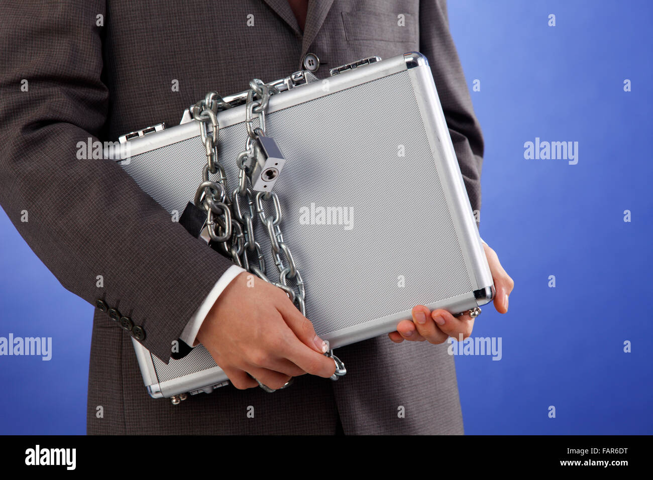 man holding the brief case with extra lock Stock Photo - Alamy