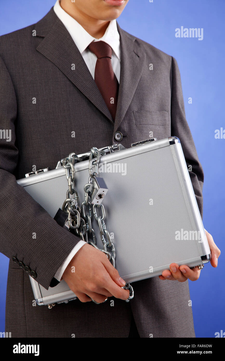man holding the brief case with extra lock Stock Photo - Alamy