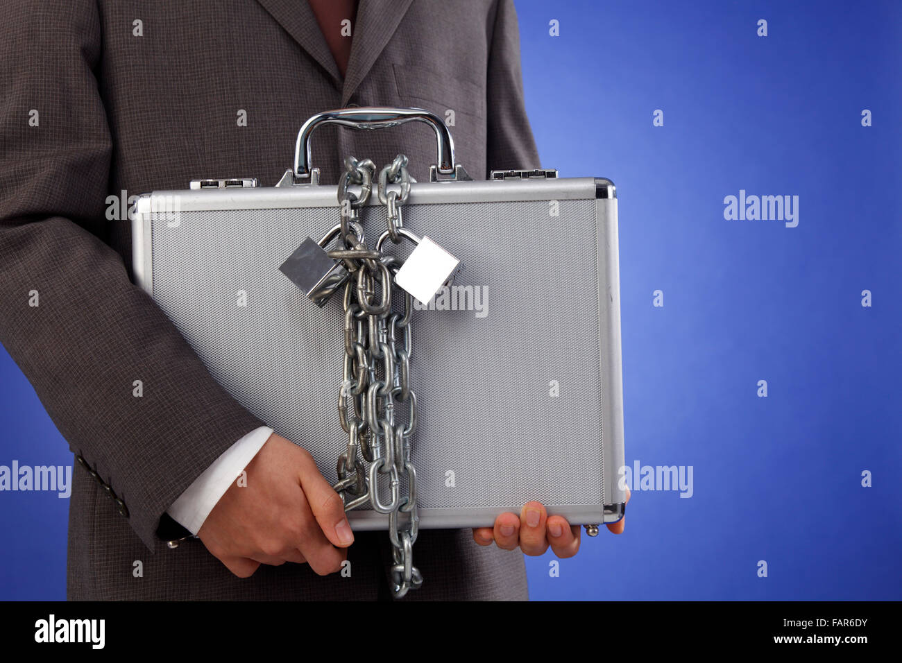 man holding the brief case with extra lock Stock Photo - Alamy
