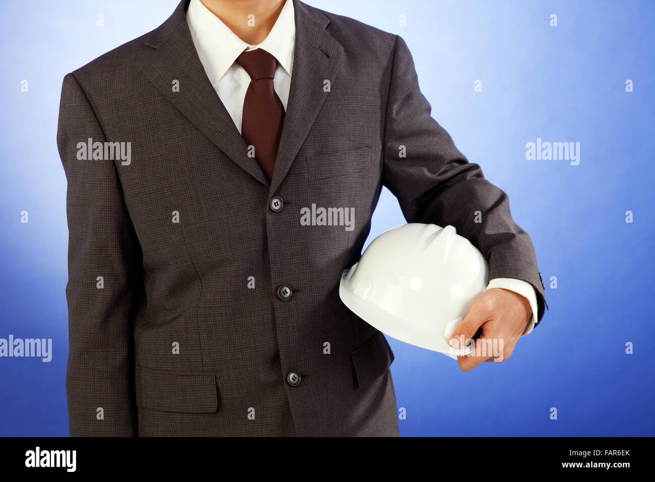 hand holding white helmet on colored background Stock Photo - Alamy