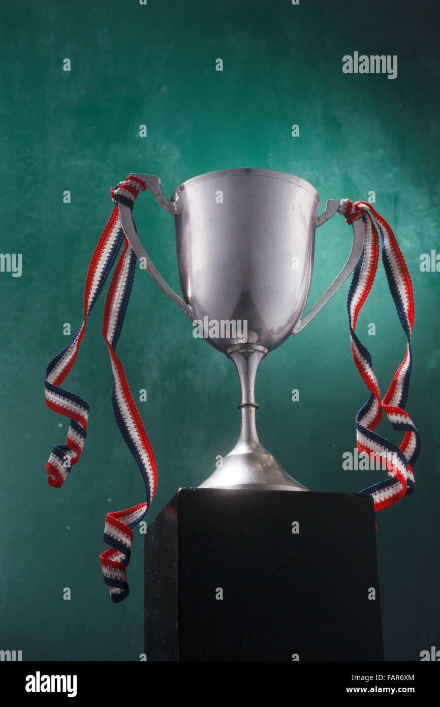 Trophy cup isolated on the green background Stock Photo - Alamy