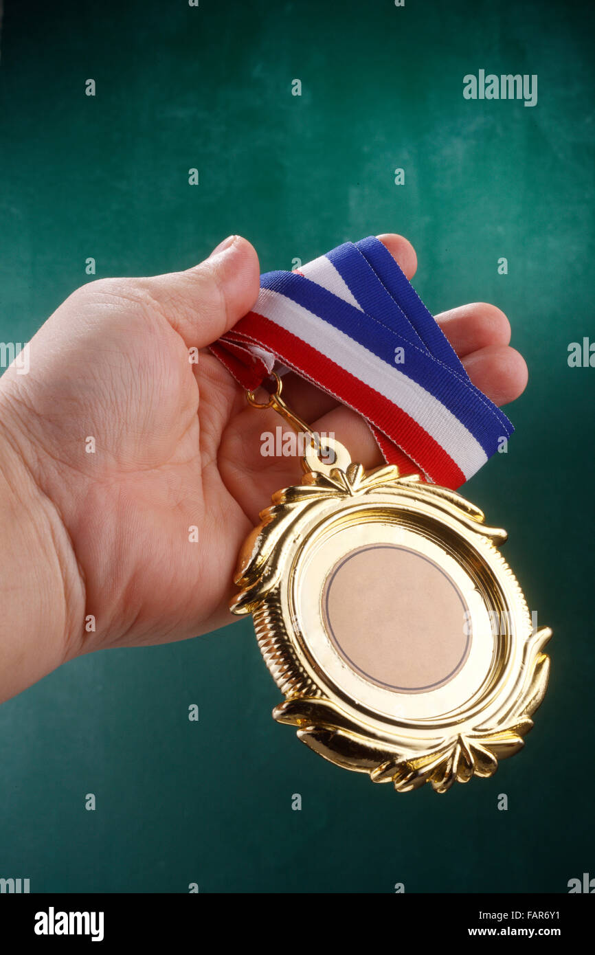 Medal on the human hand Stock Photo - Alamy