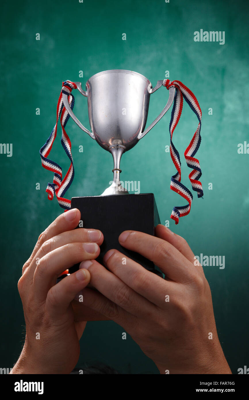 Hand holding trophy hi-res stock photography and images - Alamy