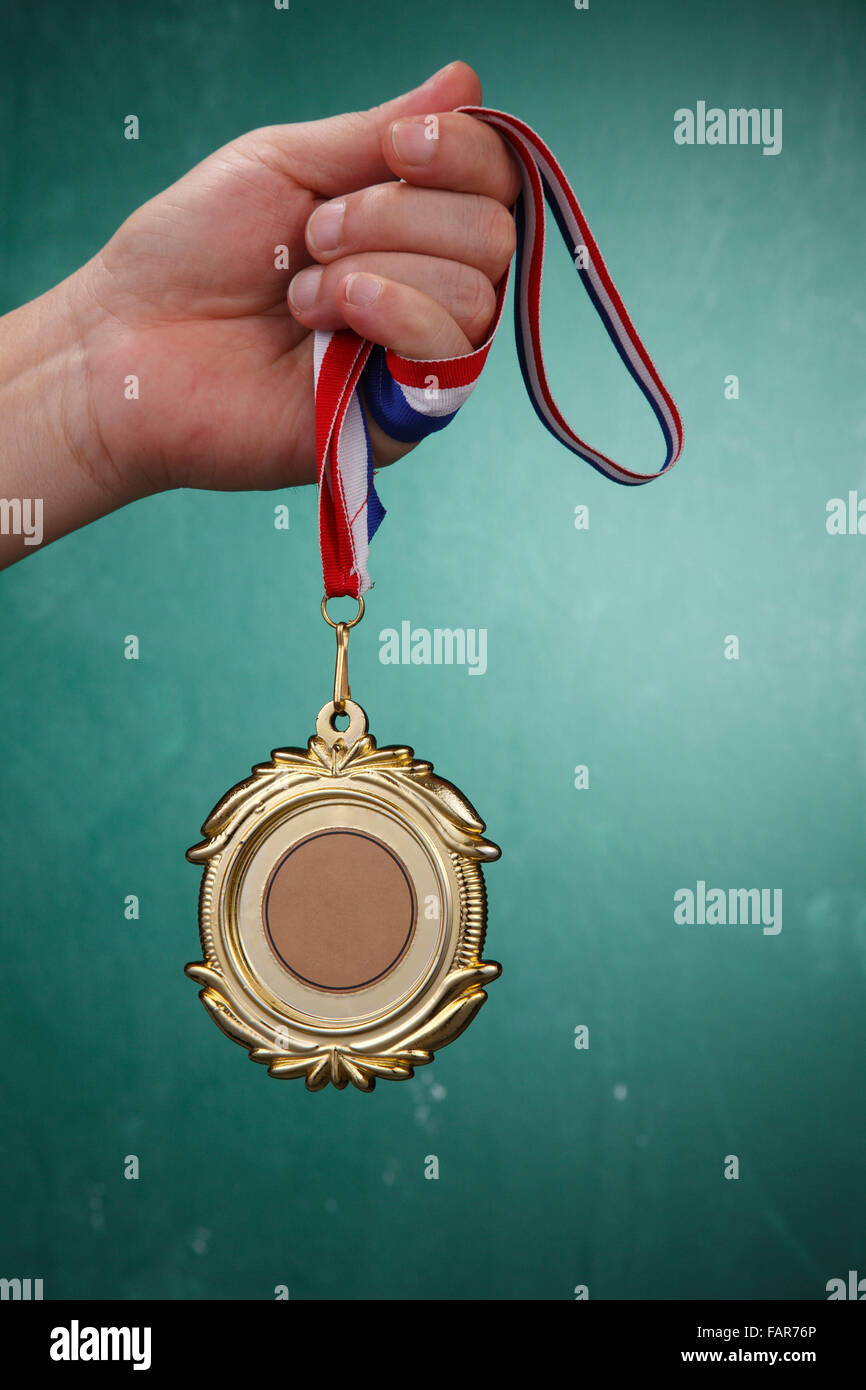 Medal hand gold ribbon hi-res stock photography and images - Alamy