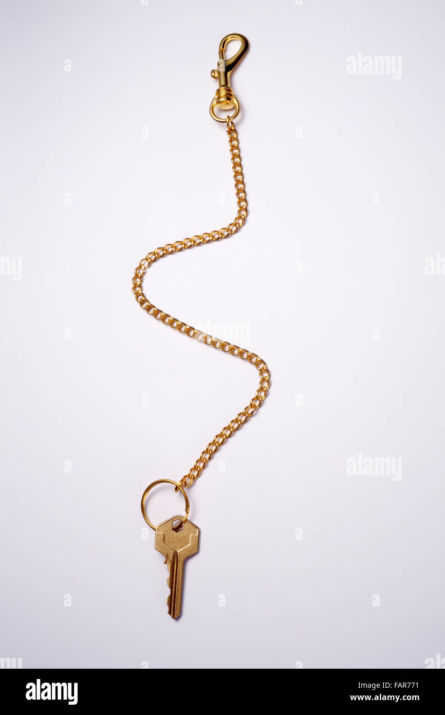 Golden chain with a key attached Stock Photo - Alamy